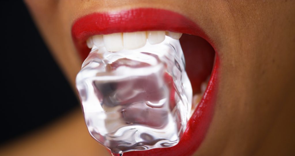 Closeup of woman biting ice - Fossum Dental Group Blog